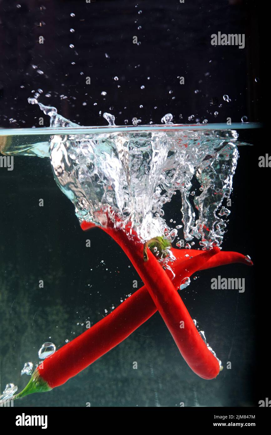 Chili in water splash Stock Photo - Alamy