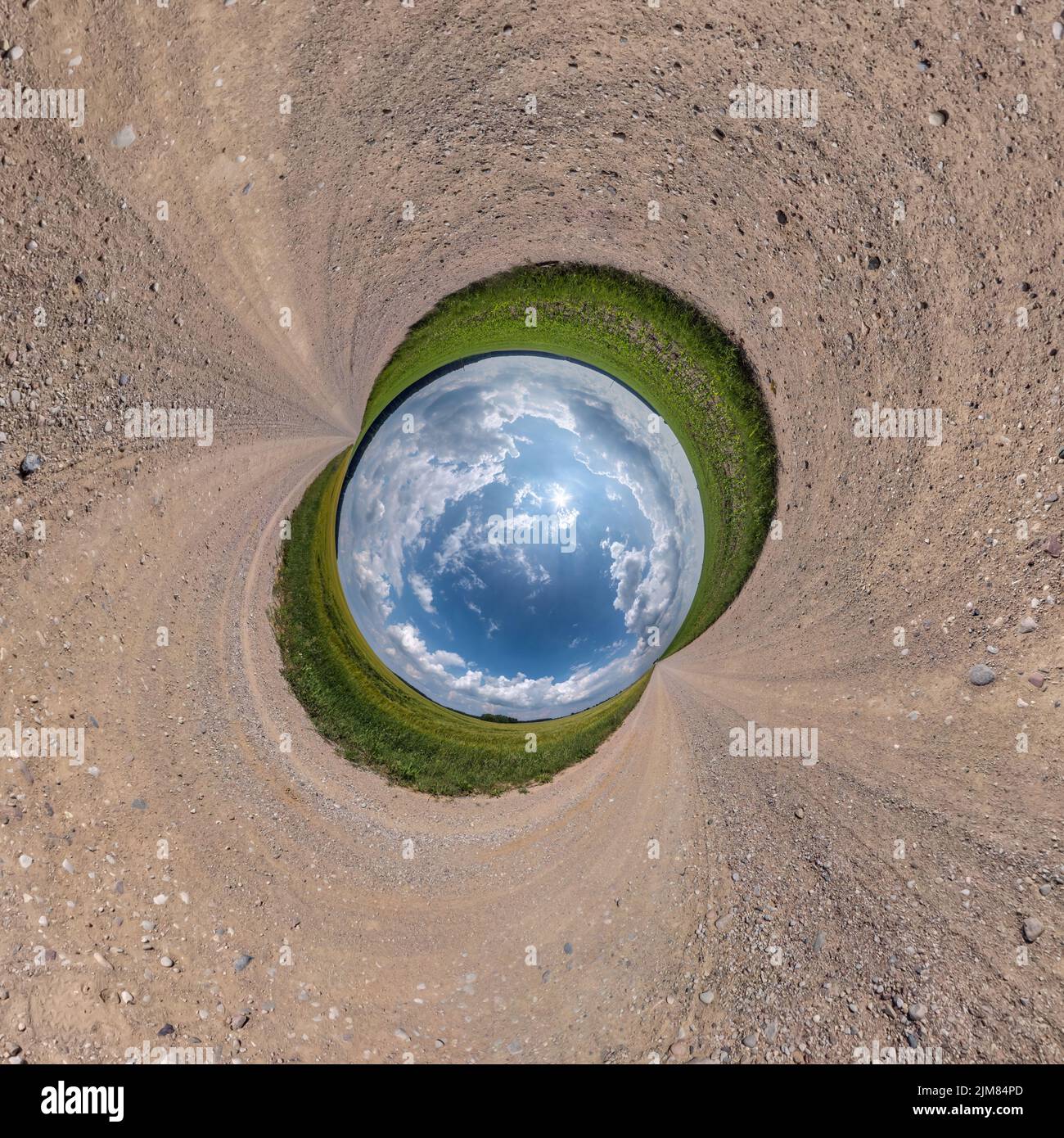 blue sphere little planet inside gravel road or field background ...