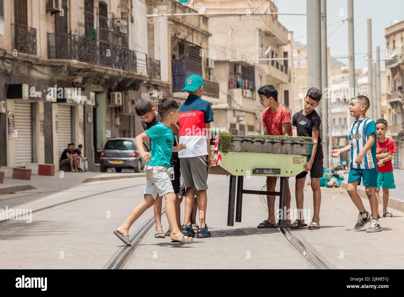 ORAN, ALGERIA, 5.7..2022: A group of algerian kids are carrying hand ...