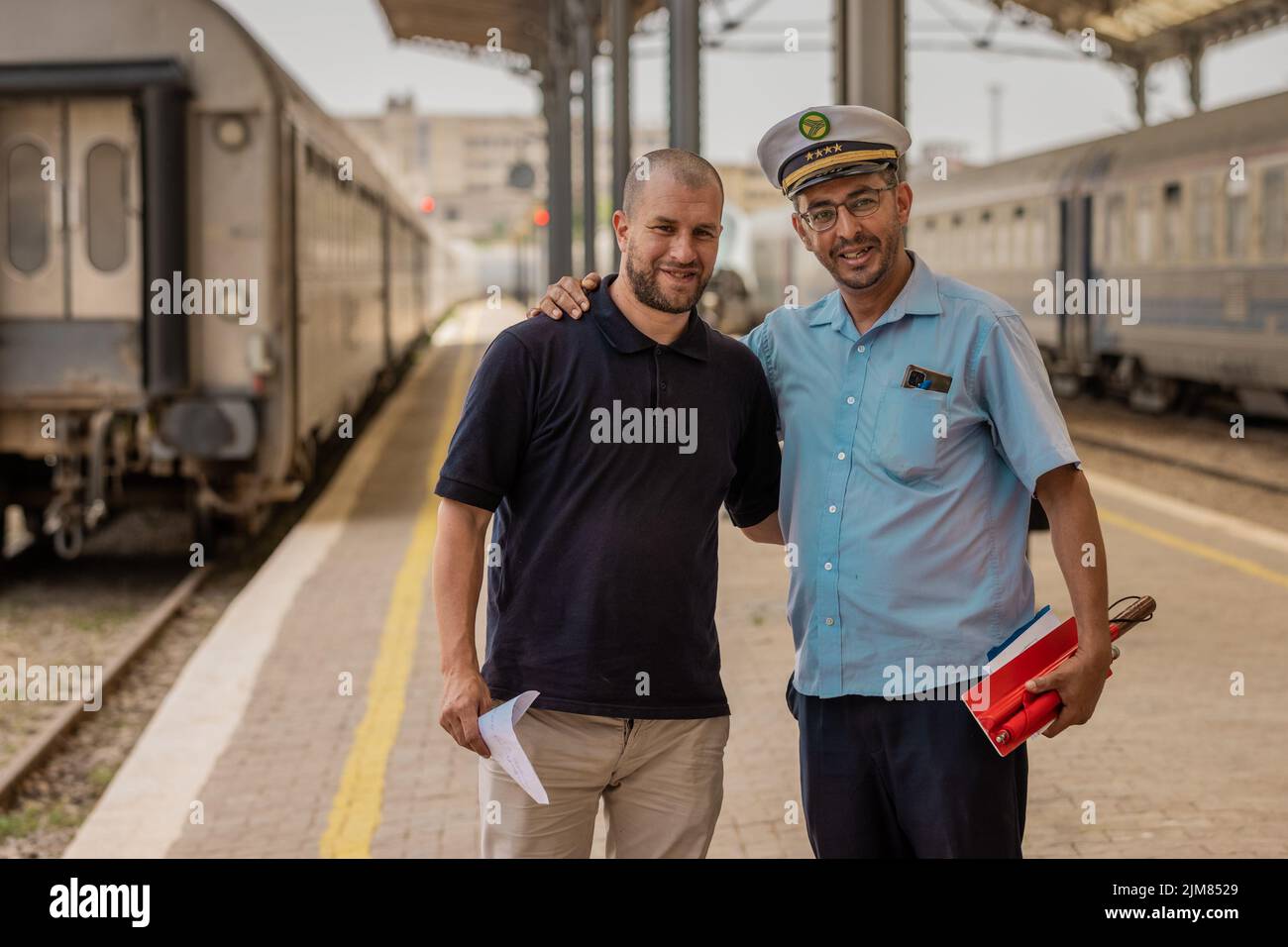 ORAN, ALGERIA, 5.7..2022: Two Algerian men are posing at a train ...