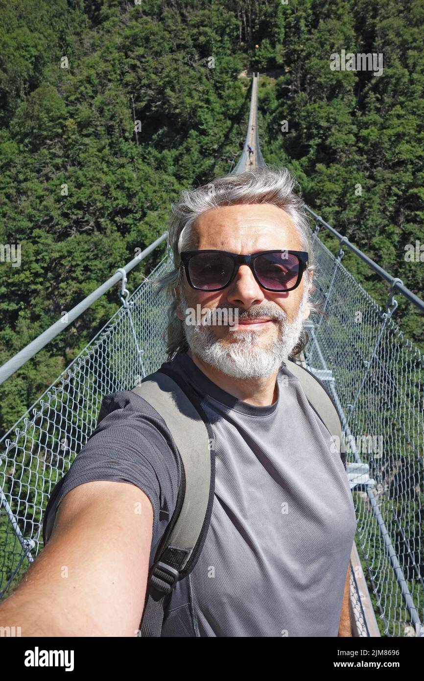The 270 meters long Tibetan bridge on the rugged valley that separates ...