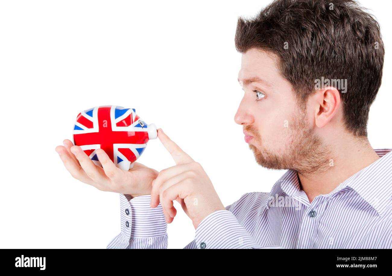 British man playing with piggy bank Stock Photo - Alamy