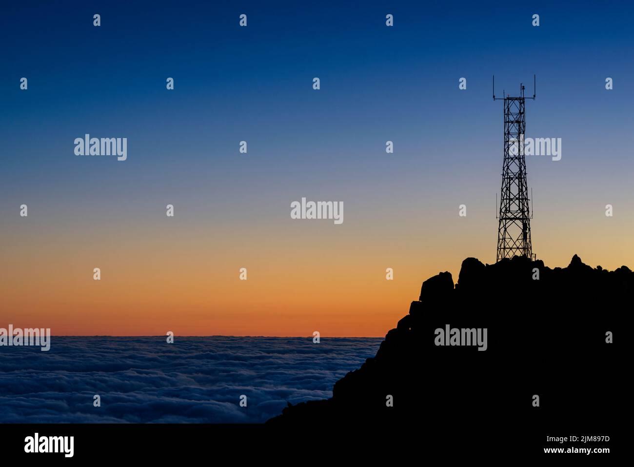 Silhouette of mast high up on mountain Stock Photo - Alamy