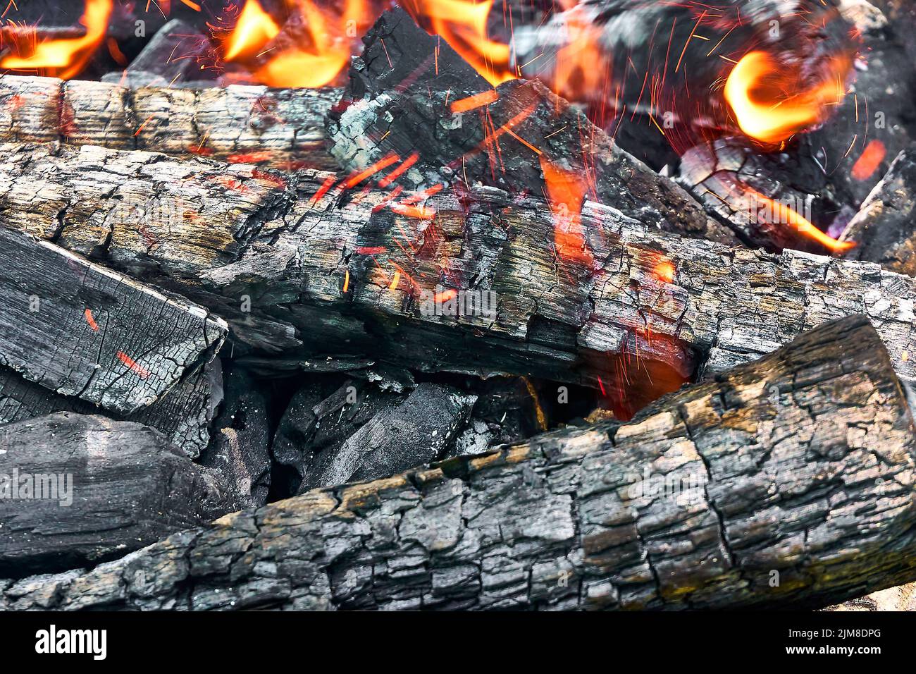 Burning coals with sparks flying in the mongal, preparation of coals ...