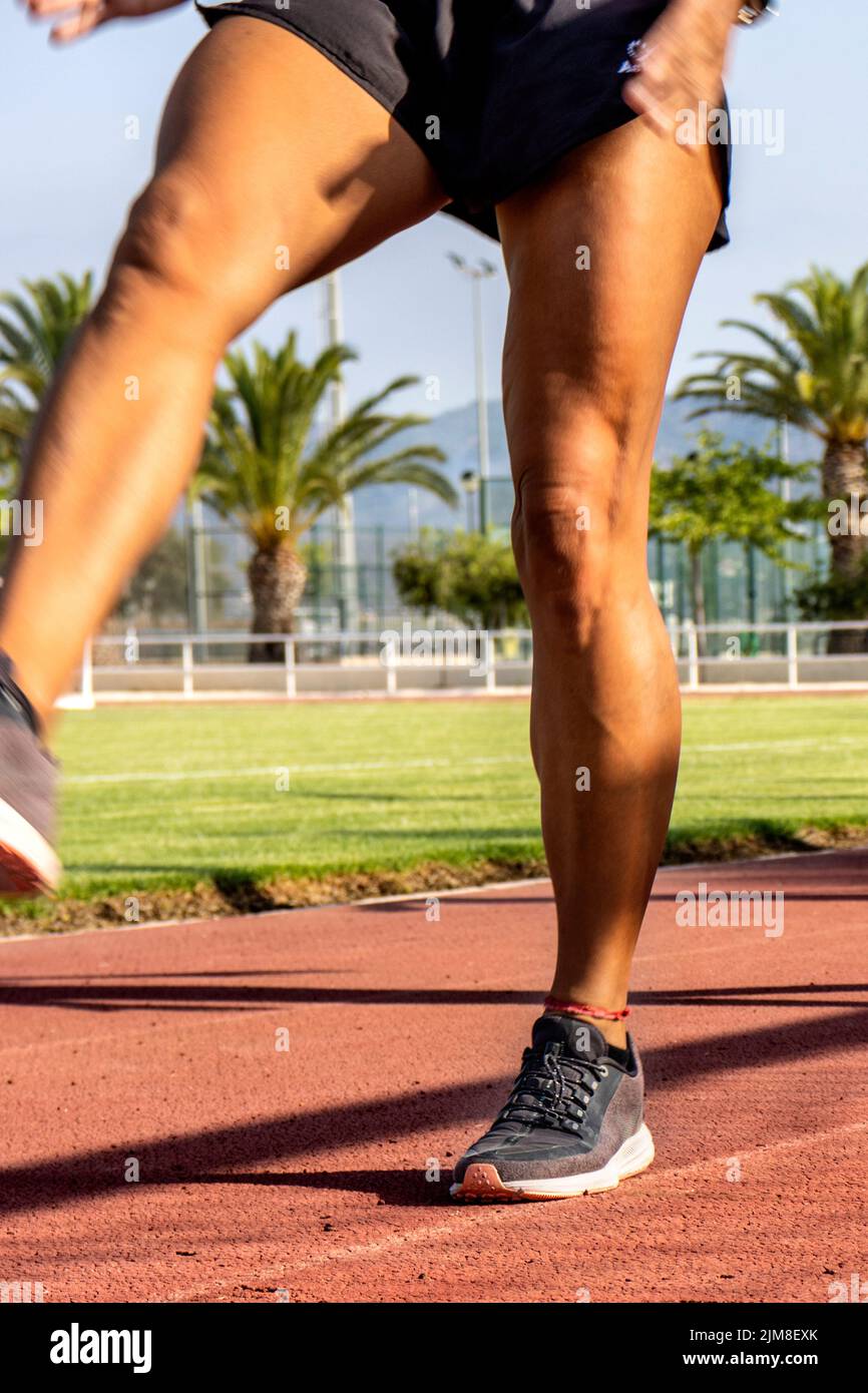 Legs of a female runner training on the stadium track. I believe I can ...