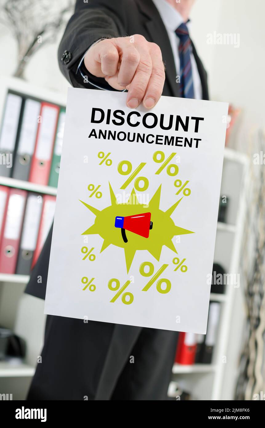 Paper showing discount announcement concept held by a businessman Stock ...