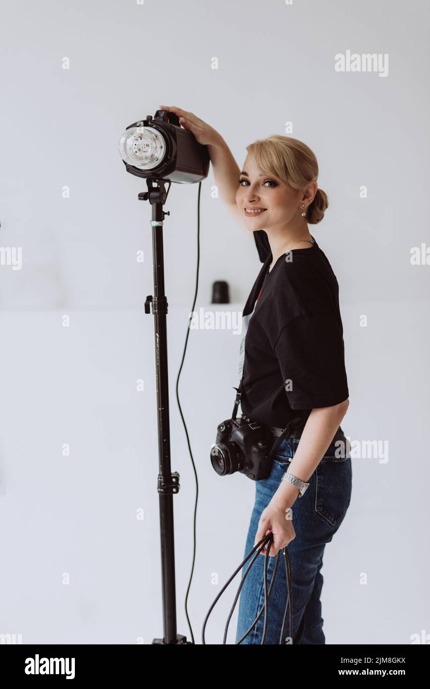 Beautiful woman photographer, journalist, while working in her studio ...