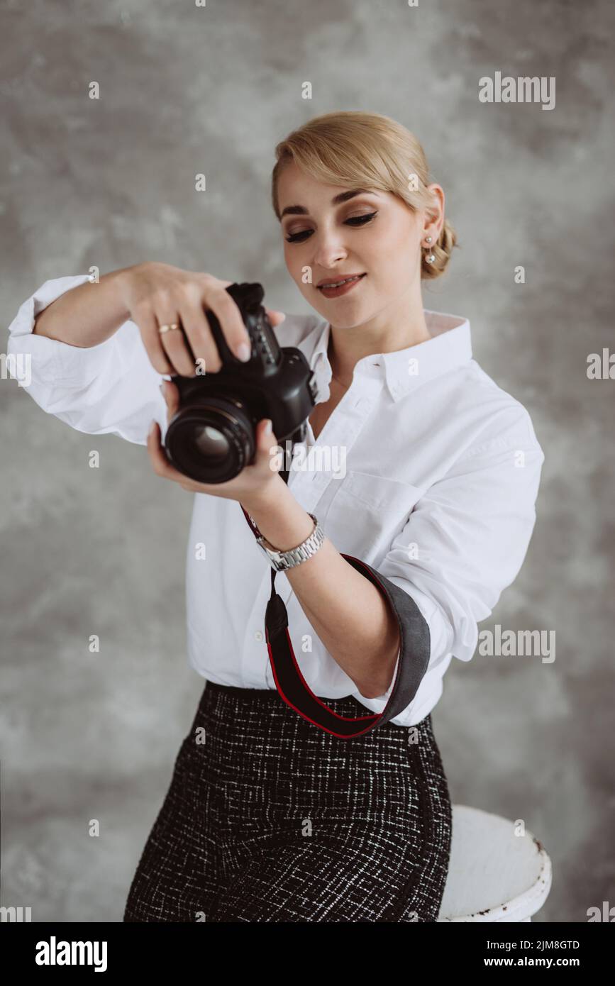 Portrait of a young female photographer while taking pictures ...