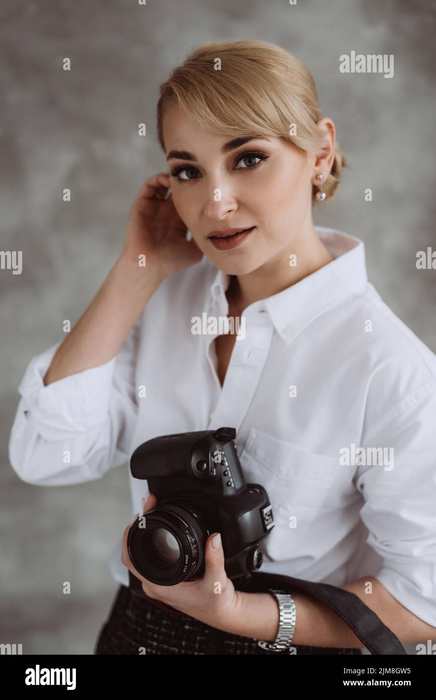 Portrait of a young female photographer while taking pictures ...