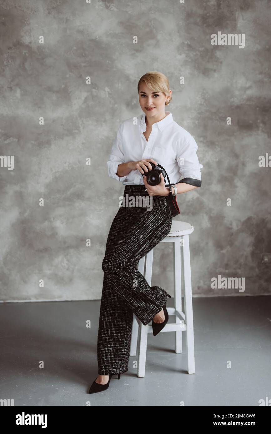 Portrait of a young female photographer while taking pictures ...