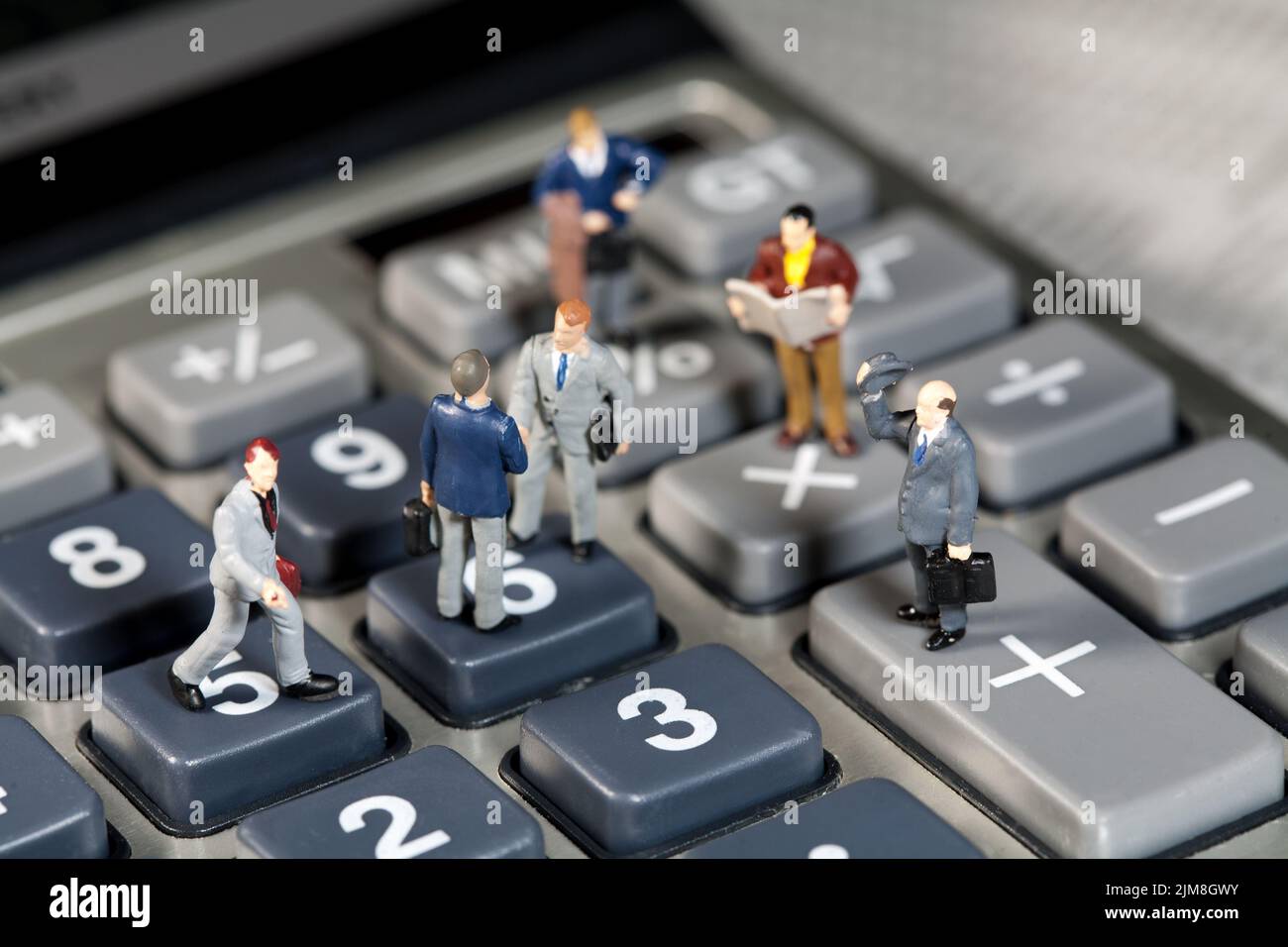 Miniature men shake hands on a calculator Stock Photo - Alamy