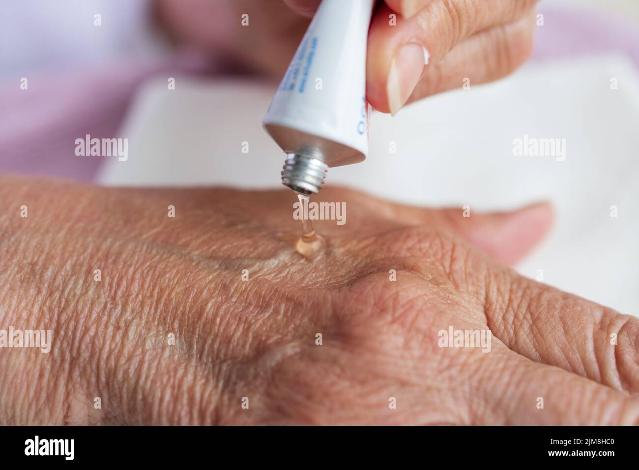 Hand applying soothing cream hi-res stock photography and images - Alamy