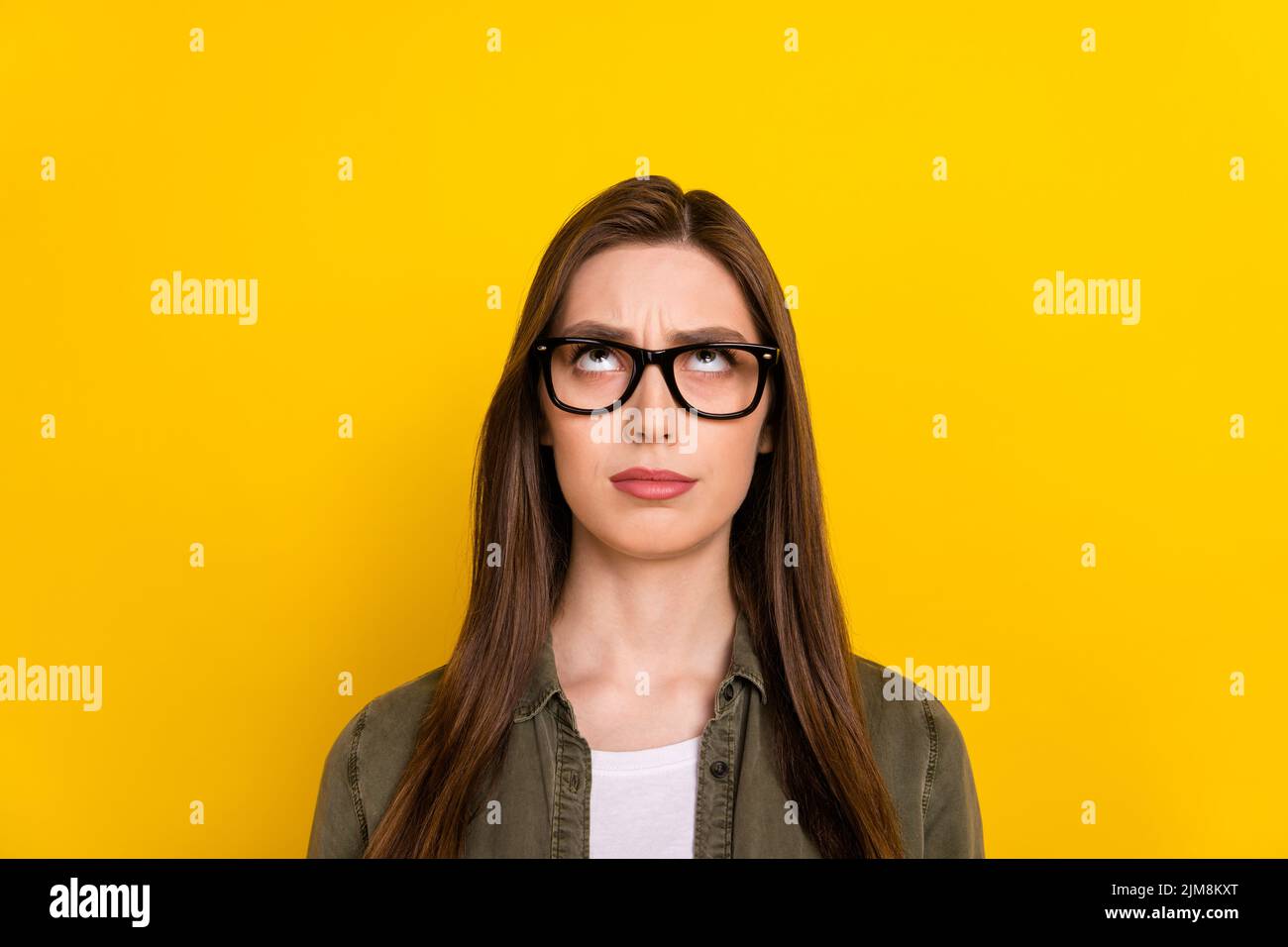 Portrait of serious strict business lady look up indifferent thinking ...