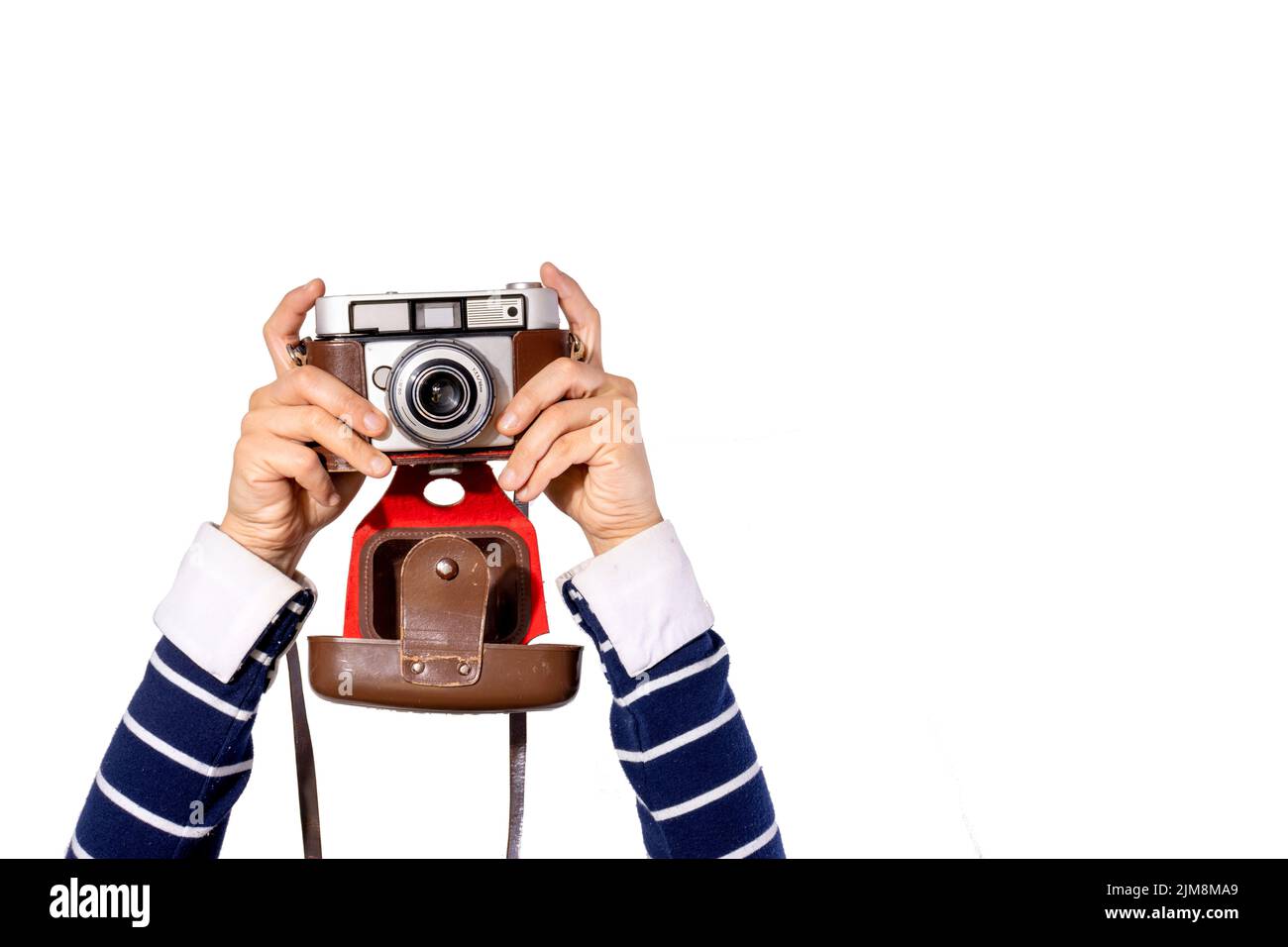 Arms up holding vintage camera isolated background Stock Photo - Alamy