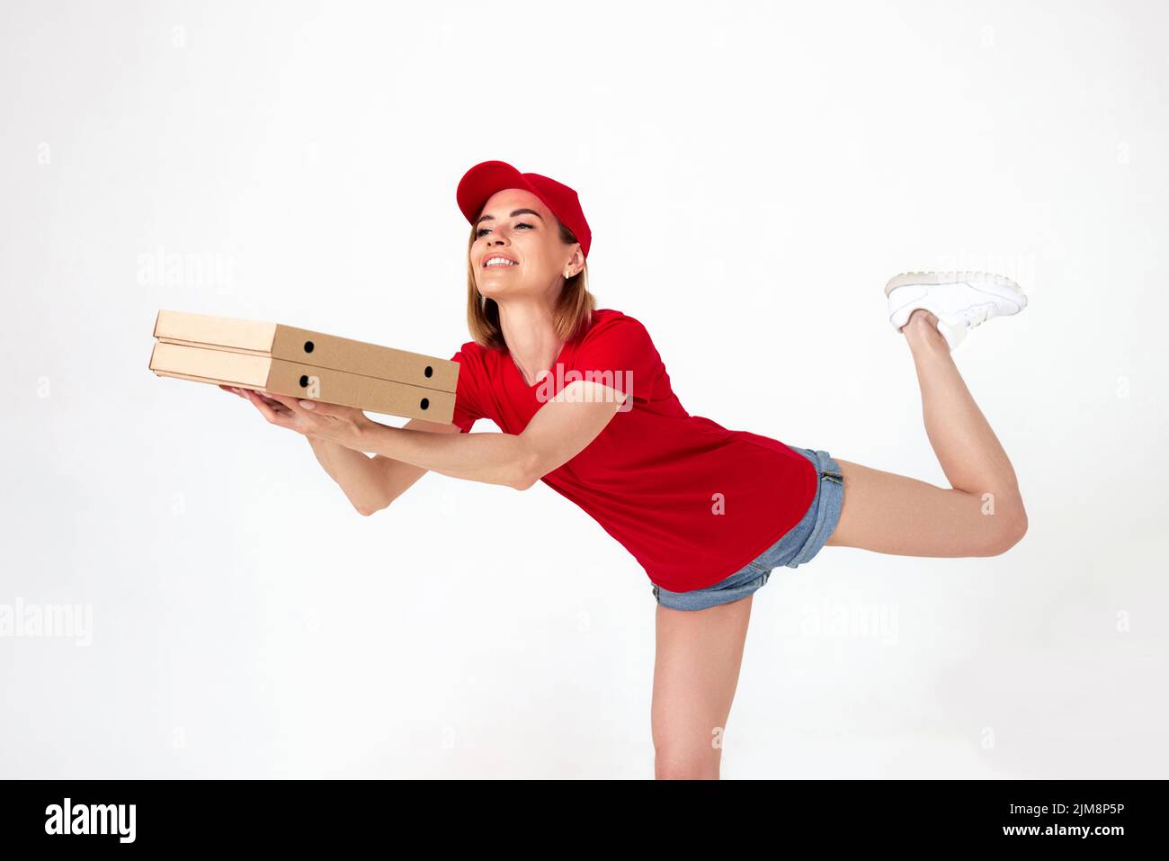 pizza delivery woman in uniform holding pizza boxes Stock Photo - Alamy
