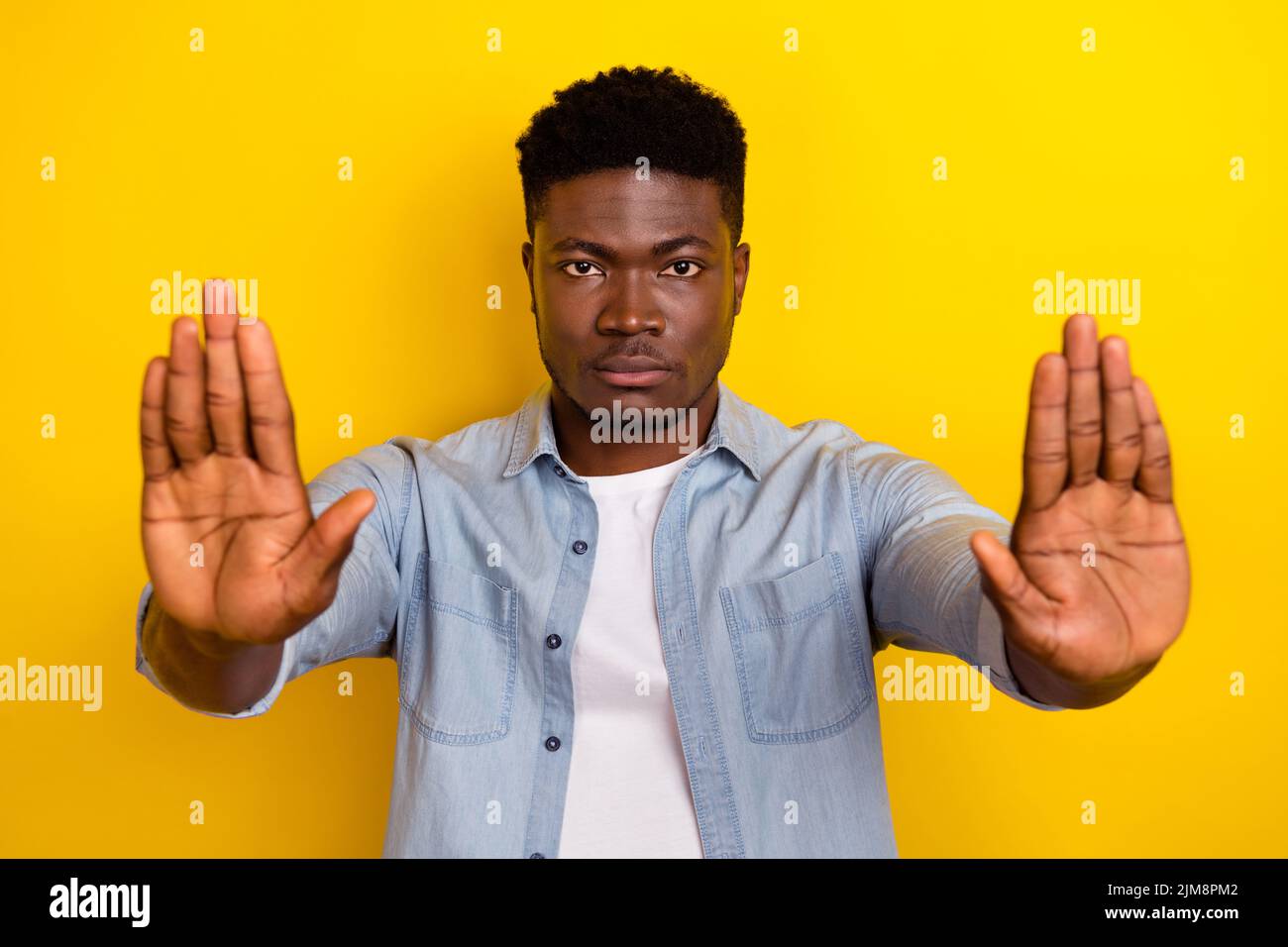 Photo of strict guy make palm stop symbol telling not move way isolated ...