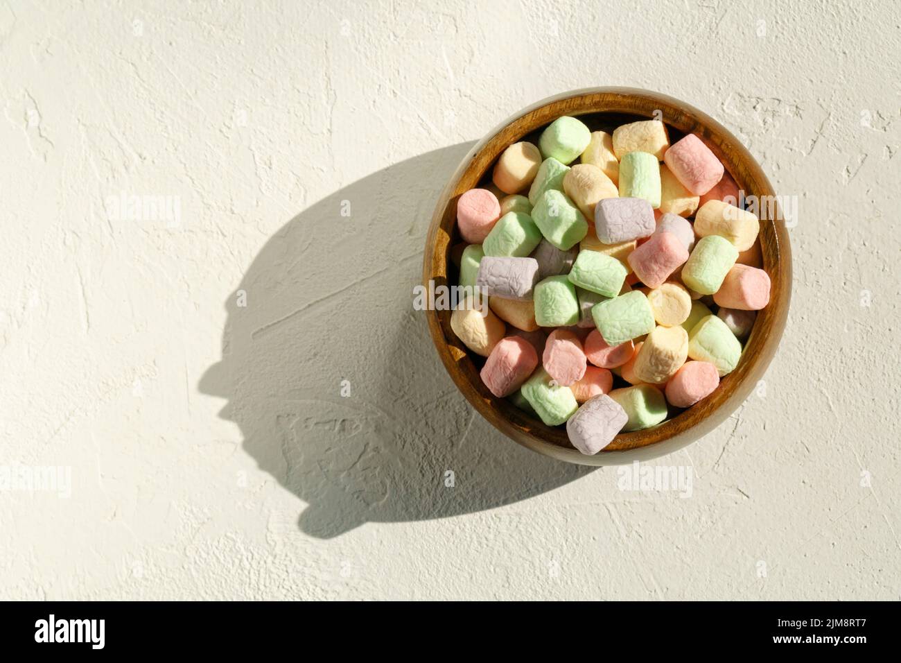Multicolored marshmallows background. Mini powder cover candies. White ...