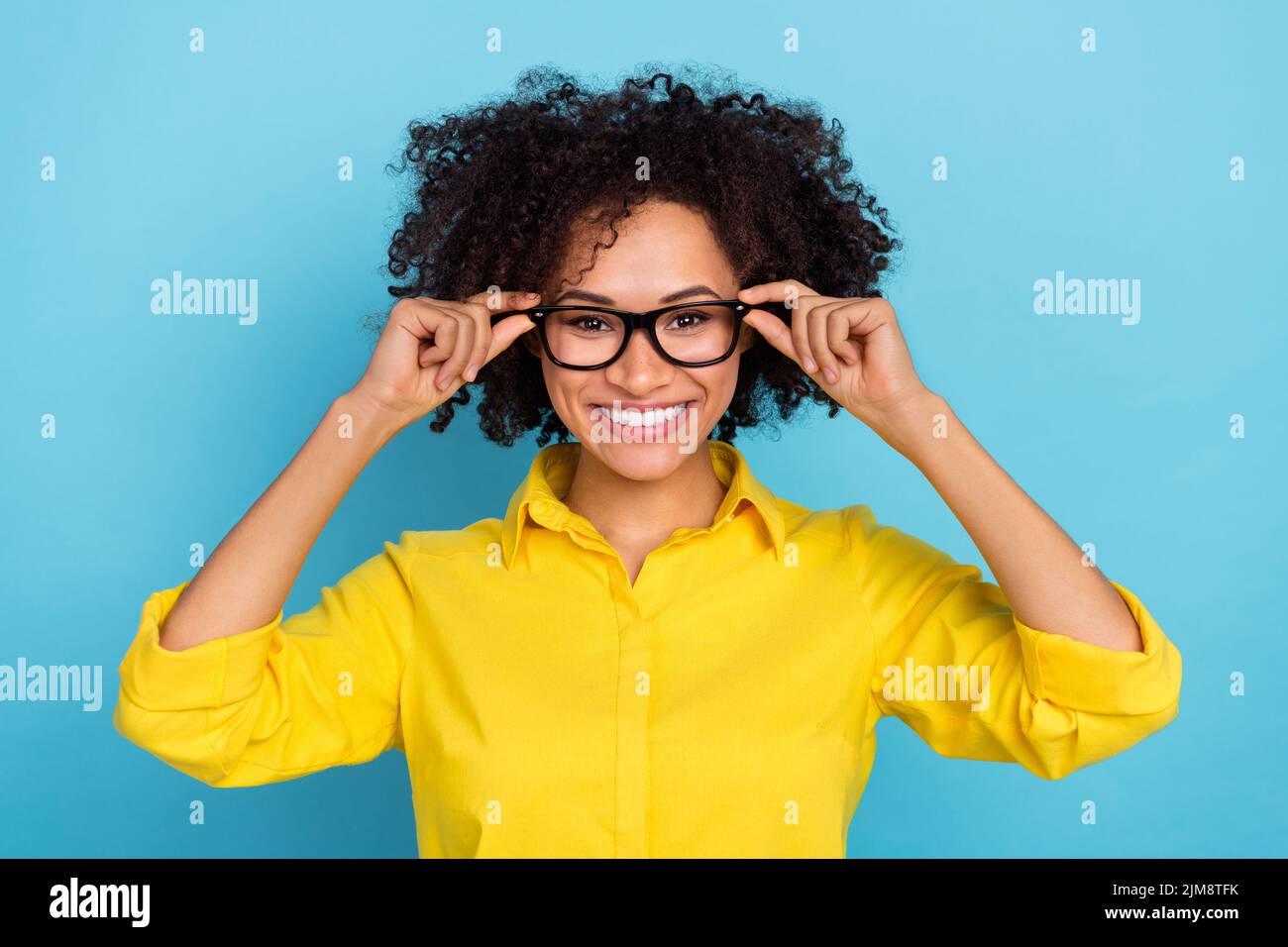 Photo of clever curly hairdo young lady wear yellow blouse eyewear ...