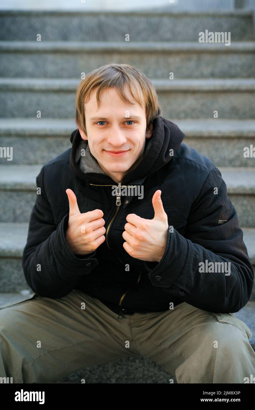 Yong man showing sign - good Stock Photo - Alamy