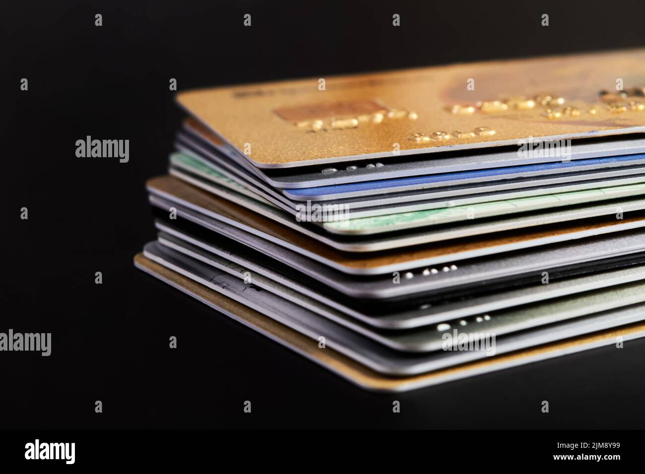 A stack of bank credit cards on dark background Stock Photo - Alamy