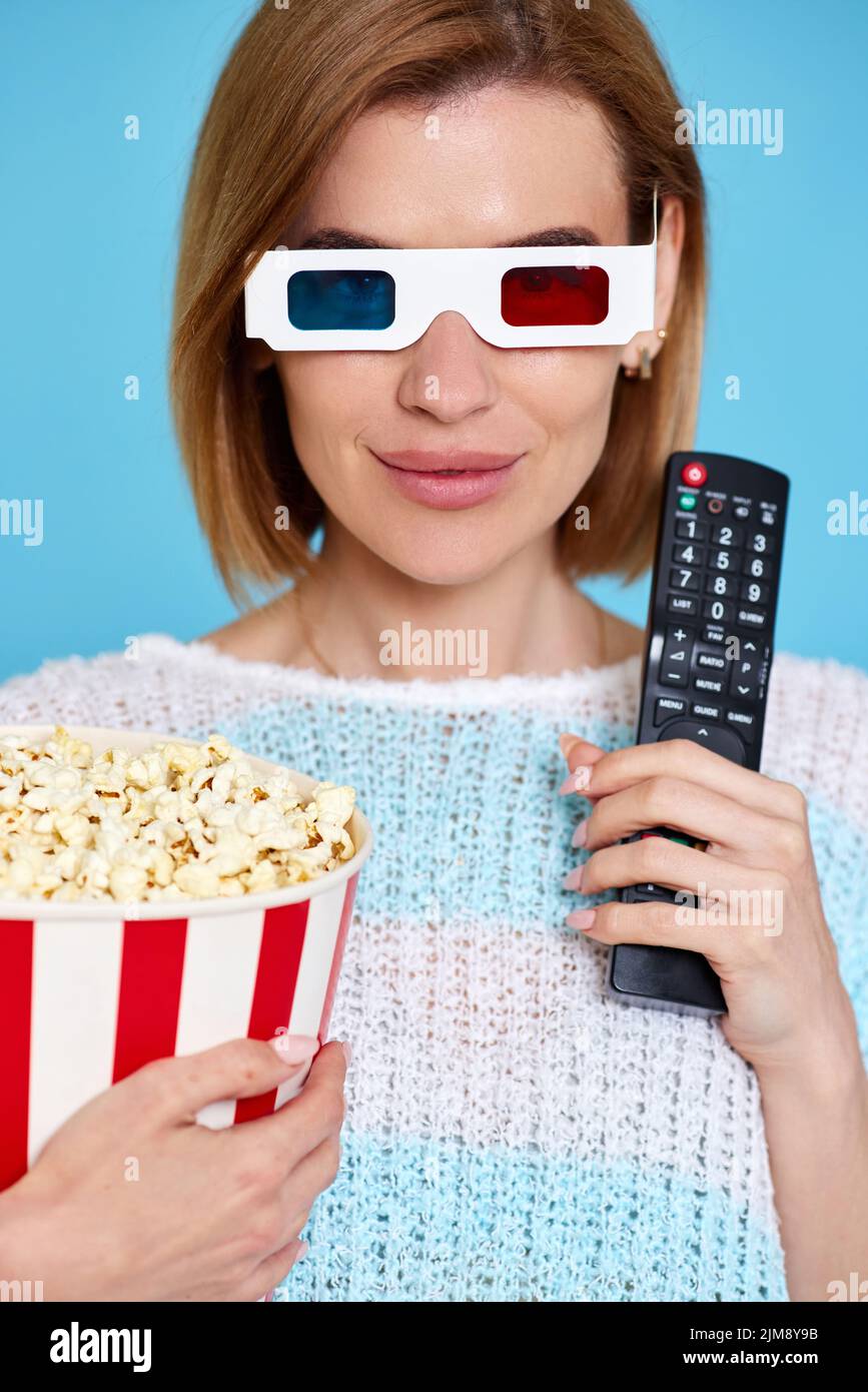 woman watching movie film, holding bucket of popcorn Stock Photo - Alamy