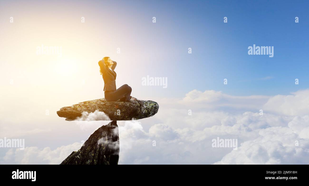 Beautiful businesswoman meditating . Mixed media Stock Photo - Alamy
