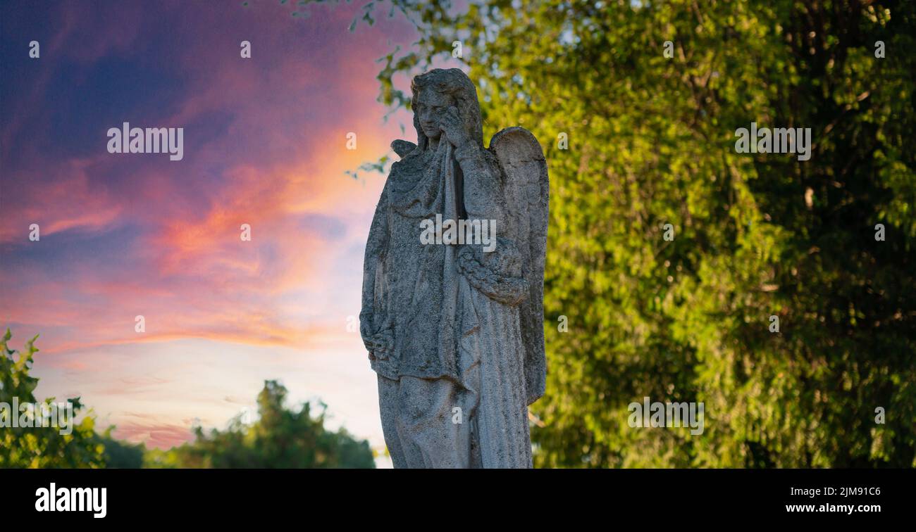 Sculpture of a weeping angel in the old Jewish cemetery in the shade of ...