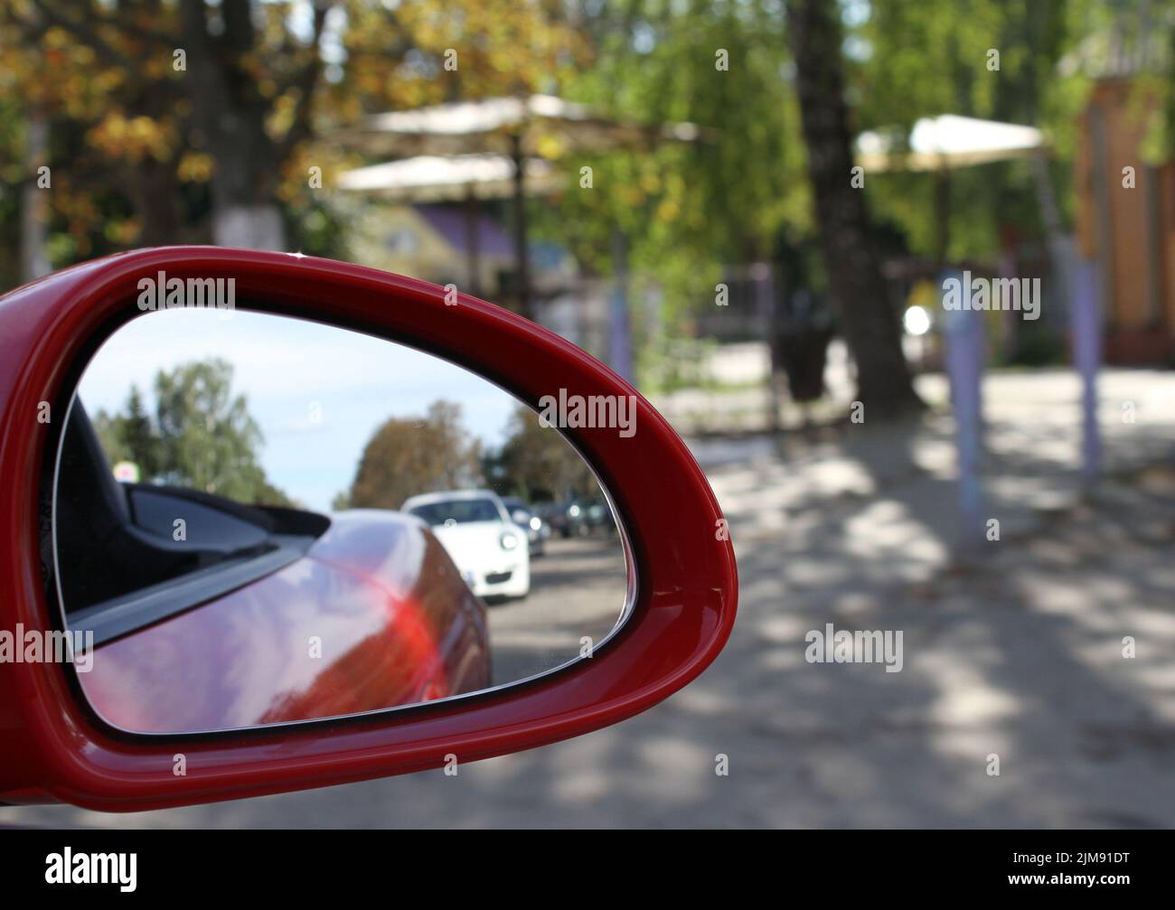 Rear vehicle on a safety distance in side car mirror at speed stock ...
