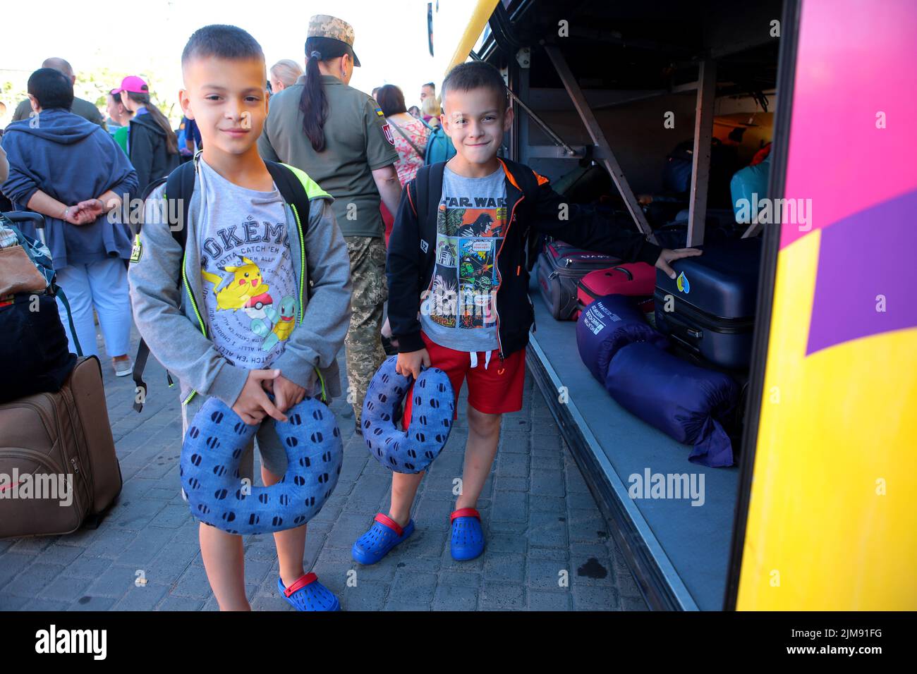 LVIV, UKRAINE - AUGUST 4, 2022 - Two boys stand by the luggage ...