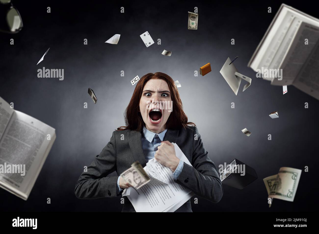 Young stressed woman ripping documents with frustrated facial ...