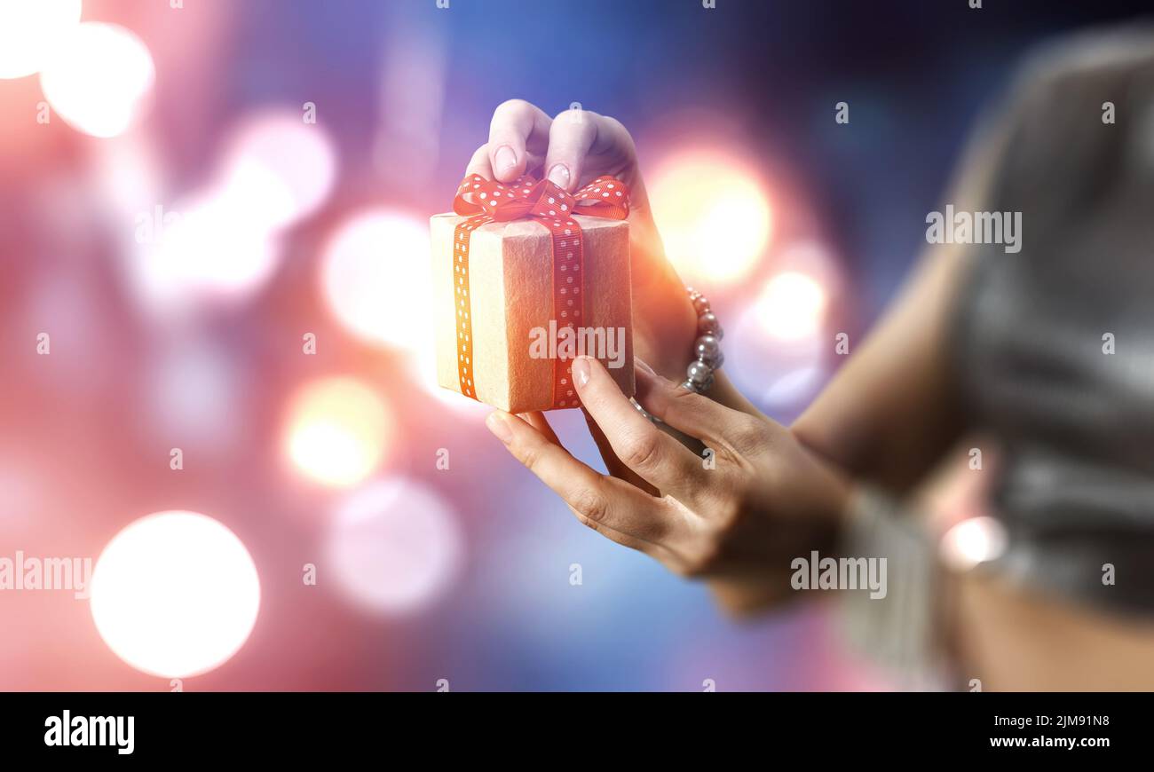 Closeup hands giving surprise gift box Stock Photo - Alamy