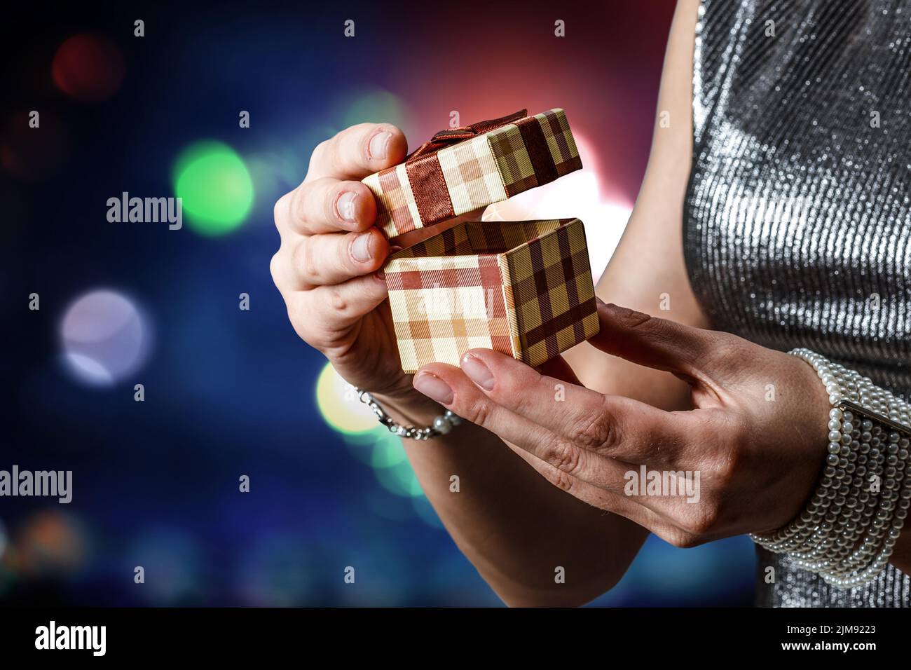 Closeup hands giving surprise gift box Stock Photo - Alamy