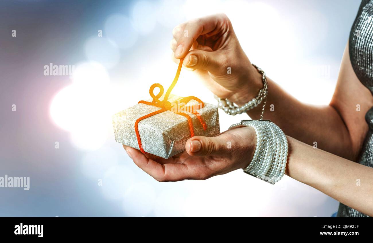 Closeup hands giving surprise gift box Stock Photo - Alamy