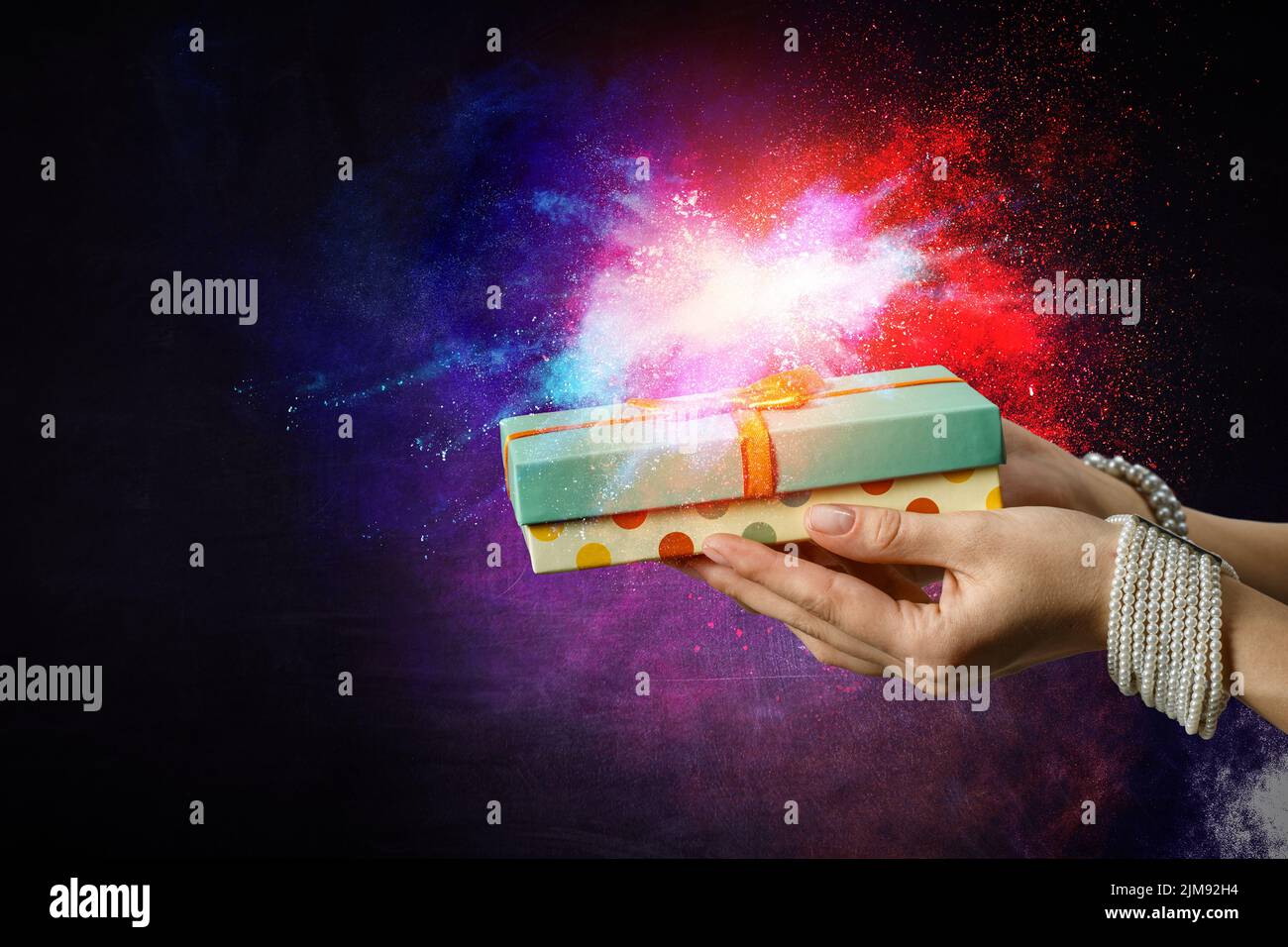 Closeup hands giving surprise gift box Stock Photo - Alamy