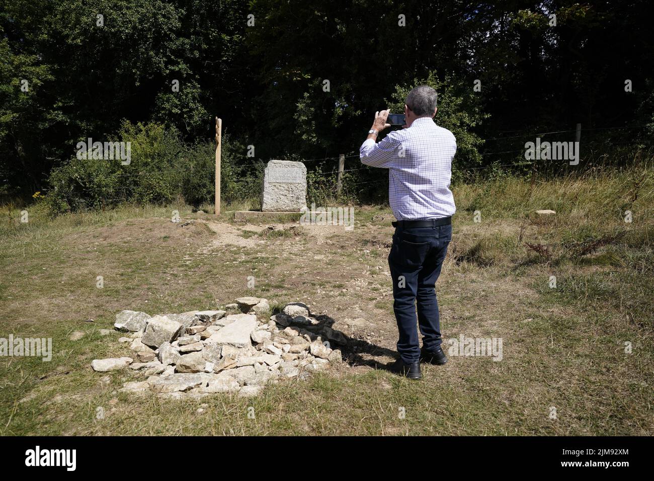 A man photographs the stone marking the spot for the traditional source ...