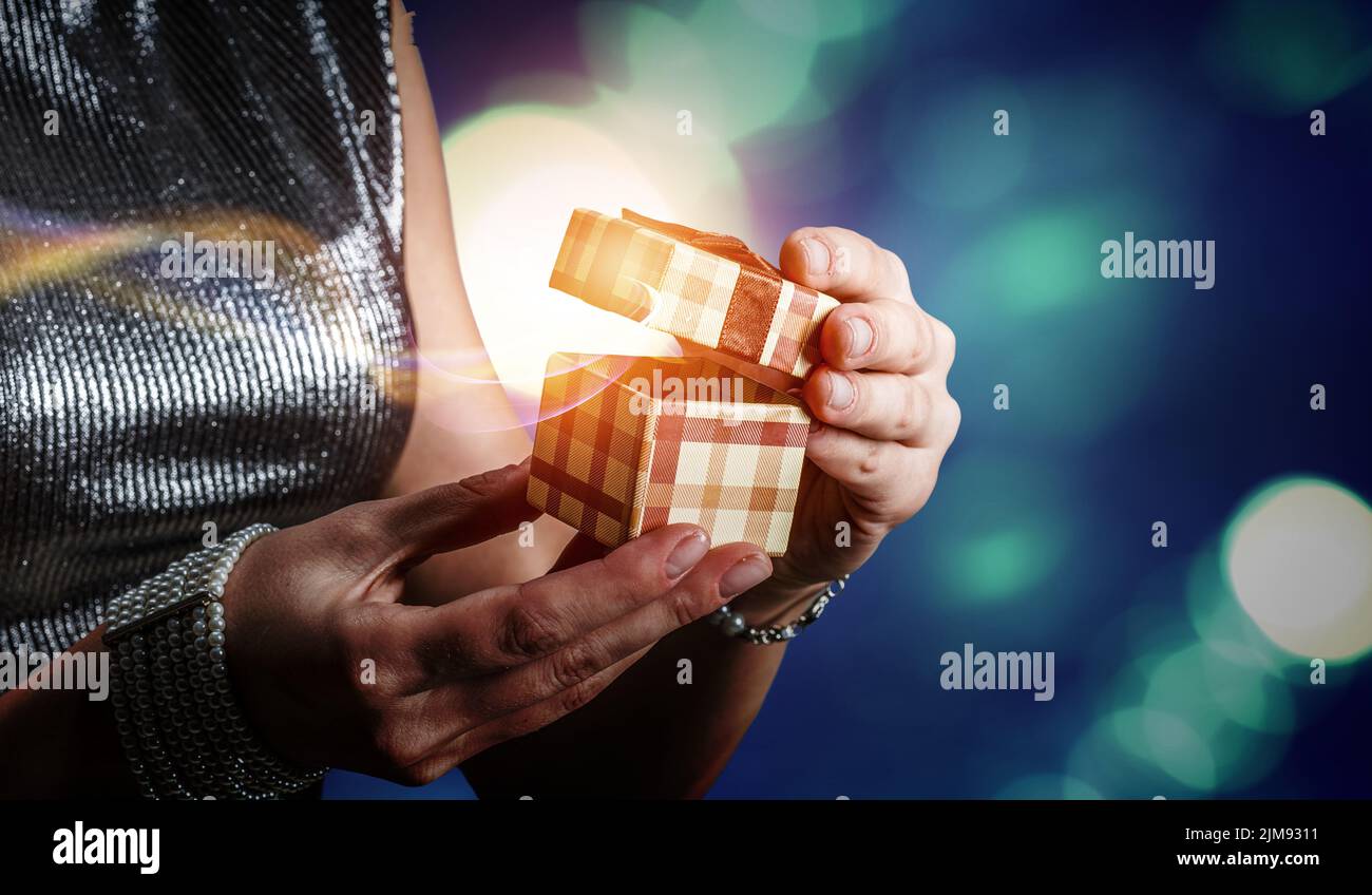 Closeup hands giving surprise gift box Stock Photo - Alamy