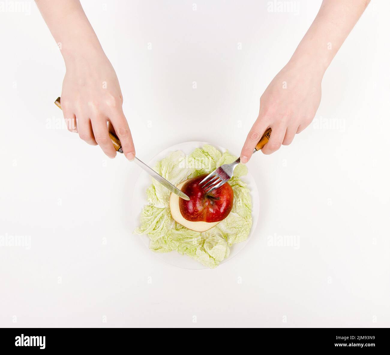 Girl holding up knife fork hi-res stock photography and images - Alamy