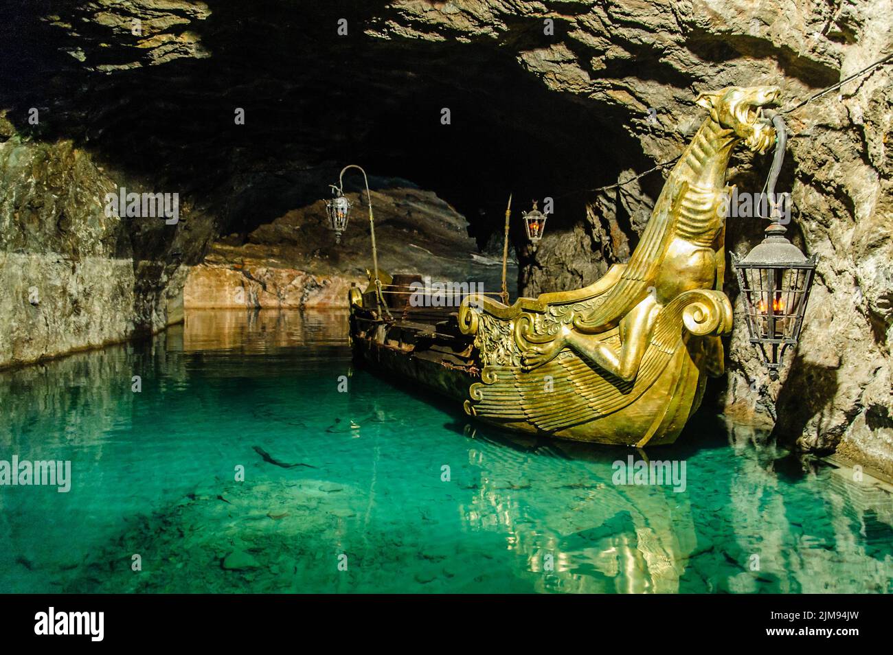 Golden boat in an underground lake Stock Photo - Alamy