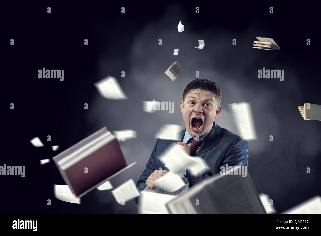 Young stressed man ripping documents with frustrated facial expression ...