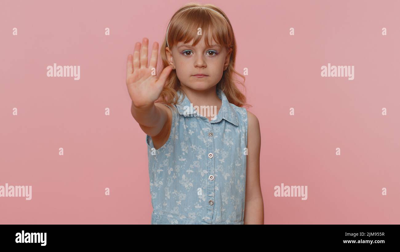 Stop gesture. Angry young preteen child girl kid say No hold palm ...