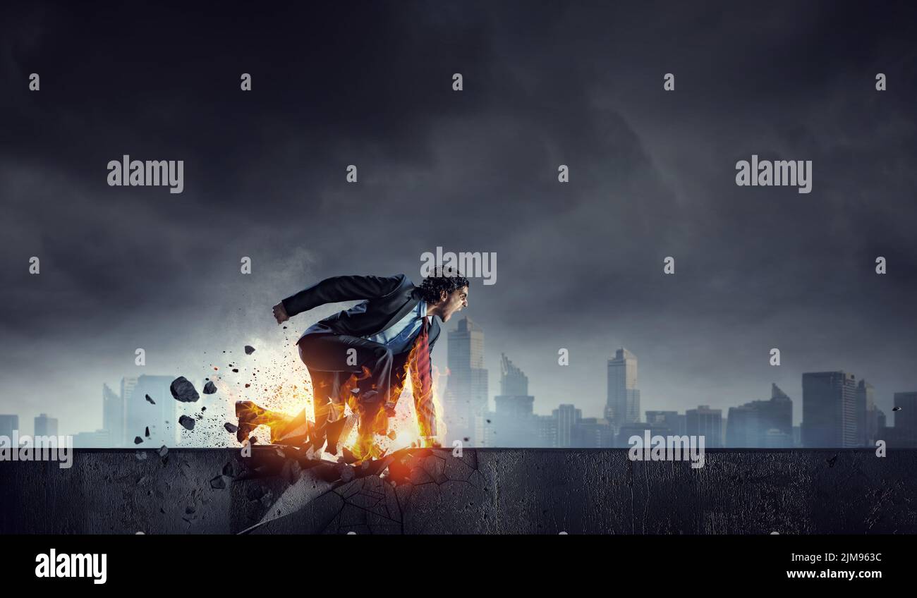 Determined businessman leaving fire trails on asphalt Stock Photo - Alamy