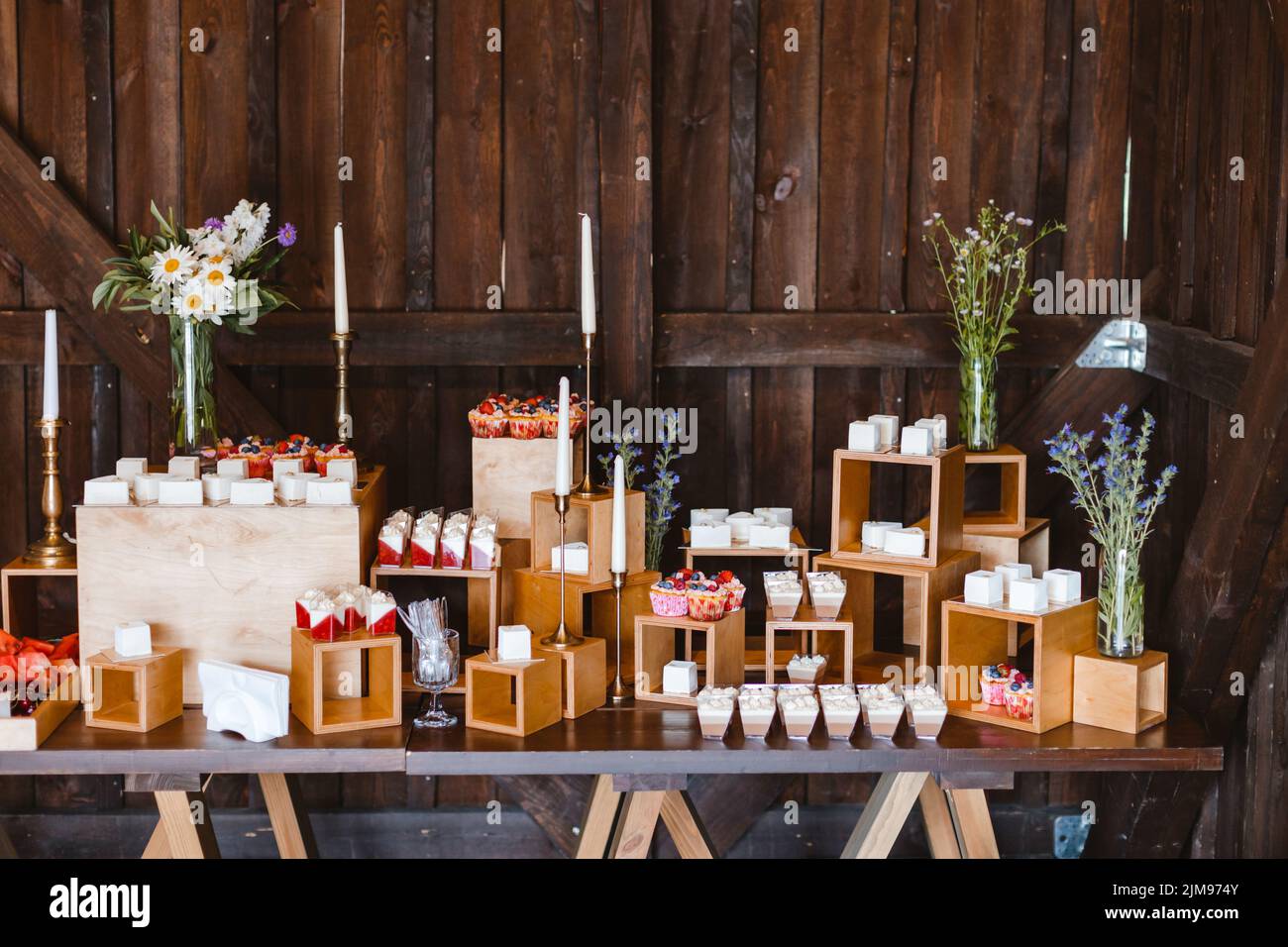 Candy bar. Festively decorated buffet table for guests. A stand with a ...
