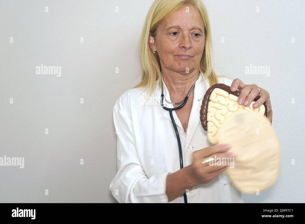 A female doctor teaches how to put a bag on the intestine Stock Photo ...