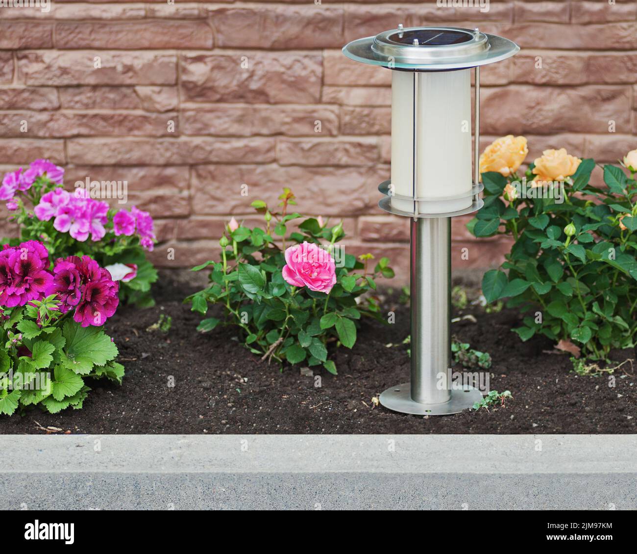 Solar-powered lamp on garden background Stock Photo - Alamy