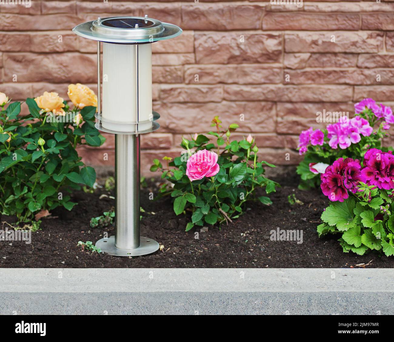 Solar-powered lamp on garden background Stock Photo - Alamy