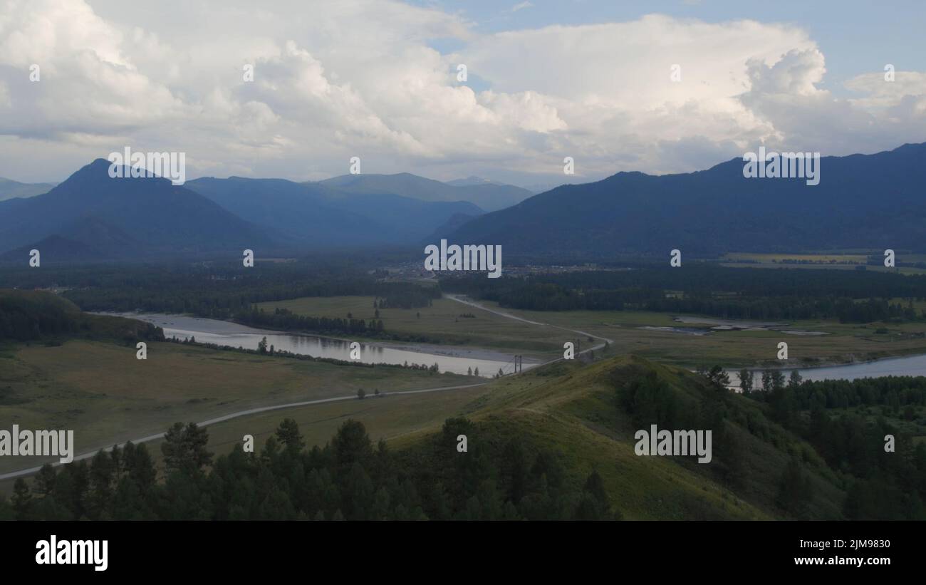 Aerial of majestic river Katun and valley of Altai under sunset sky ...