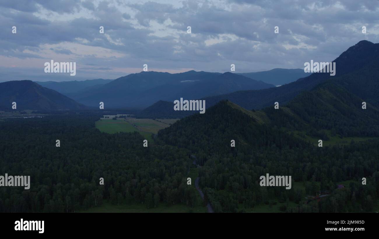 Aerial of majestic mountains in valley of Altai under sunset sky ...