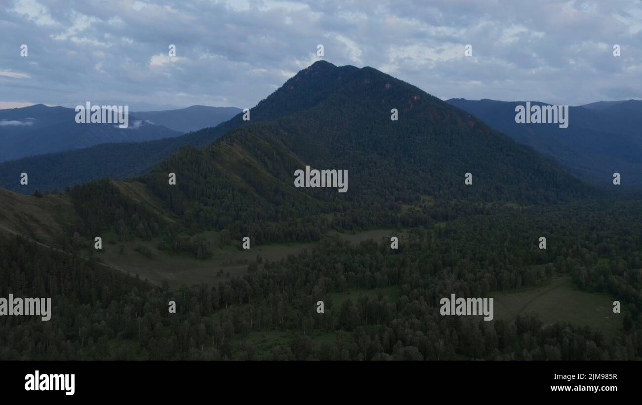 Aerial of majestic mountains in valley of Altai under sunset sky ...