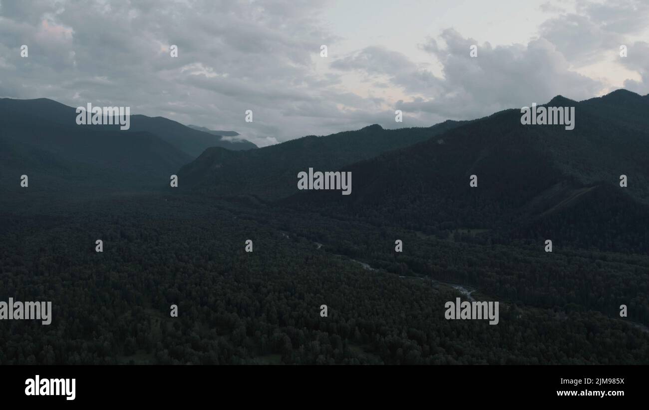 Aerial of majestic mountains in valley of Altai under sunset sky ...
