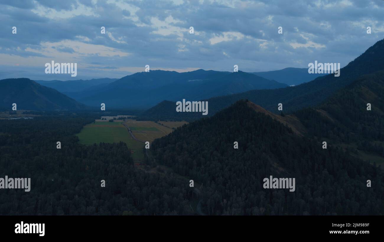 Aerial of majestic mountains in valley of Altai under sunset sky ...